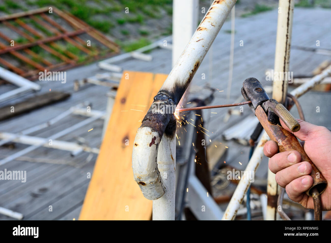 The master works on welding the iron to repair the handrail fence Stock ...