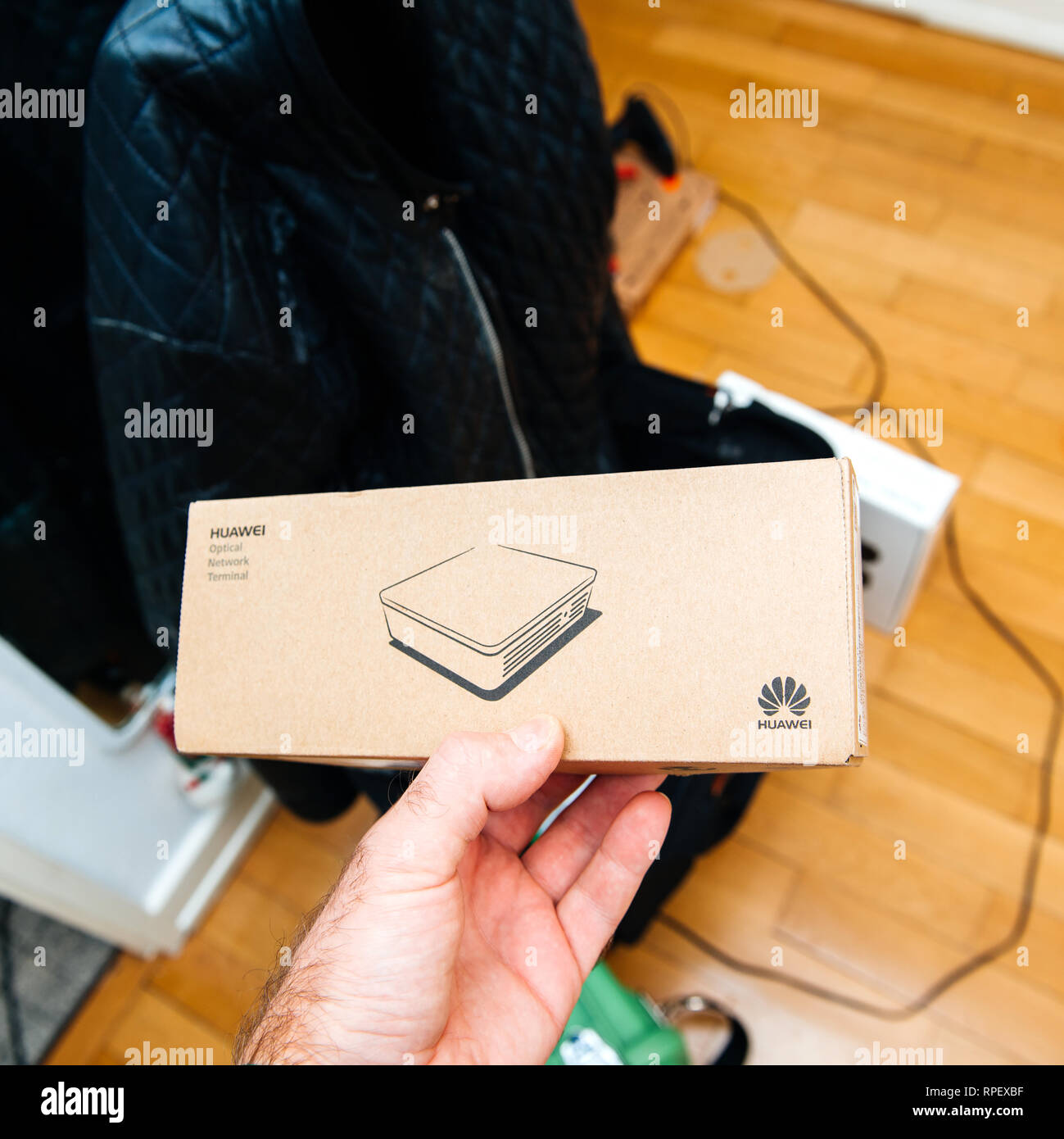 PARIS, FRANCE - JAN 15, 2018: Technician hand holding HUAWEI optical ...