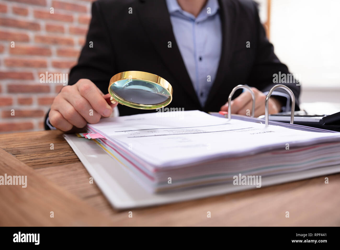 Close-up Of A Businessman's Hand Examining Invoice Through Magnifying ...