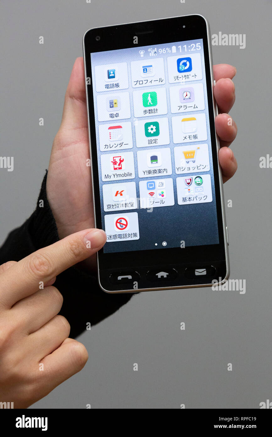 A member of staff shows a smartphone Y!mobile ''Kantan Sumaho'' during ...