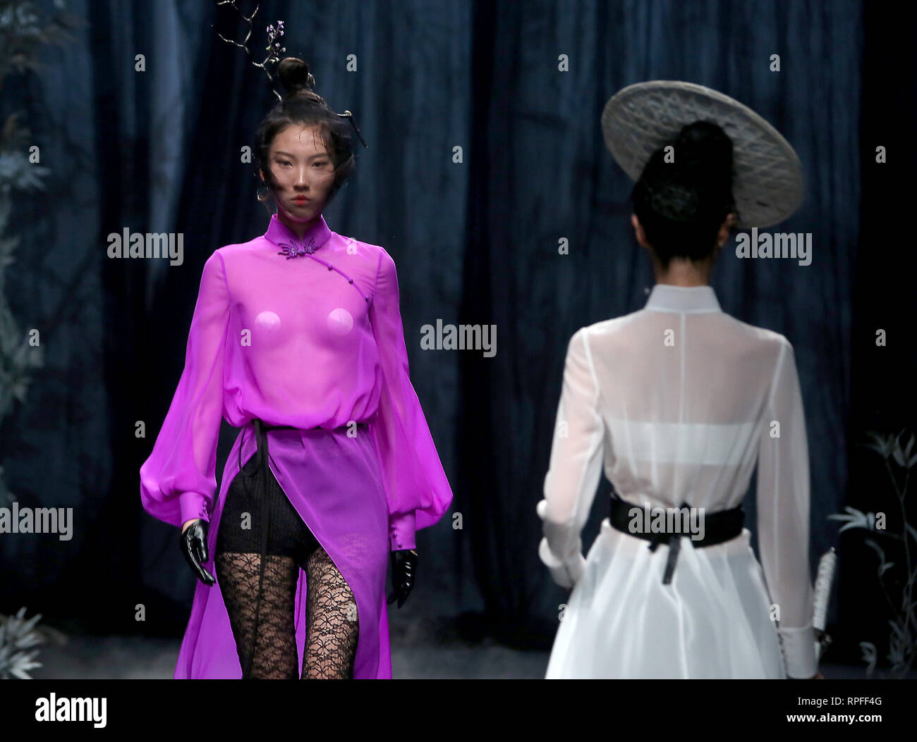 Beijing, China. 1st Apr, 2018. Models wear clothing by designer Xiong ...