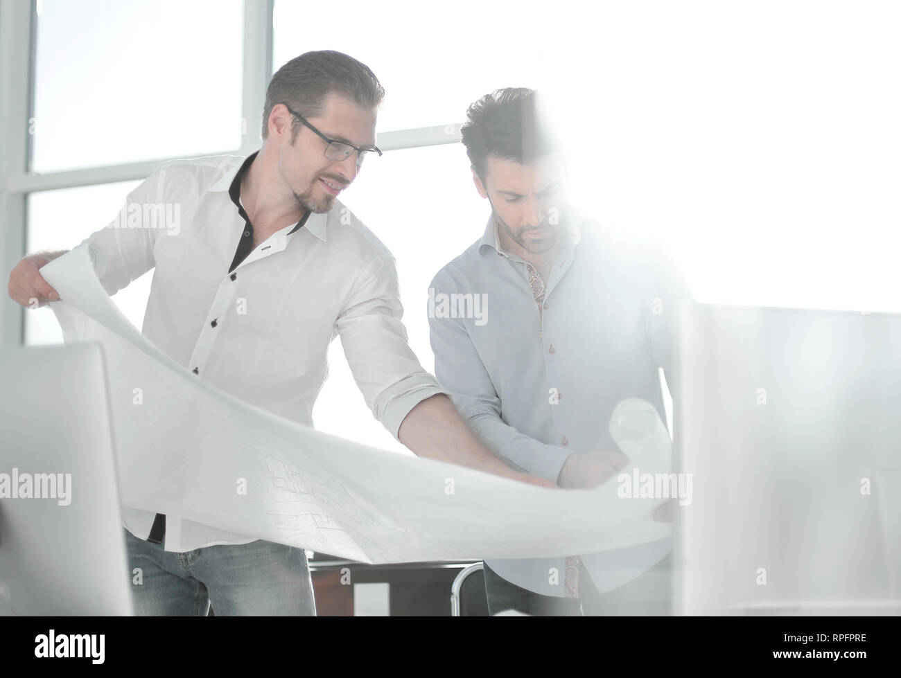employees discussing drawings for new project Stock Photo - Alamy