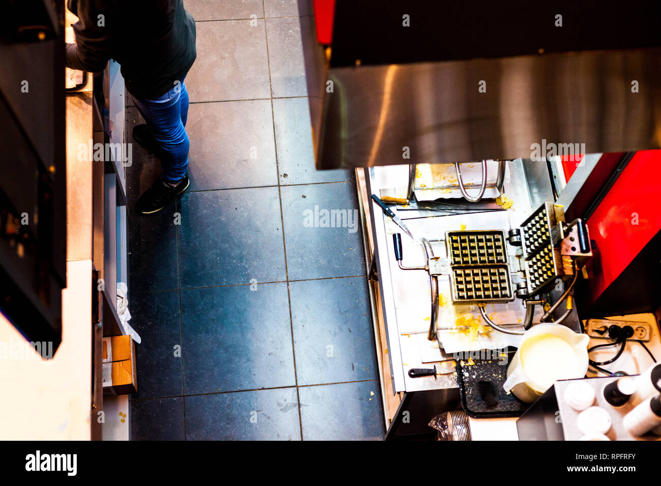 Top view of kitchen interior with man washing dishes. Overview of messy ...