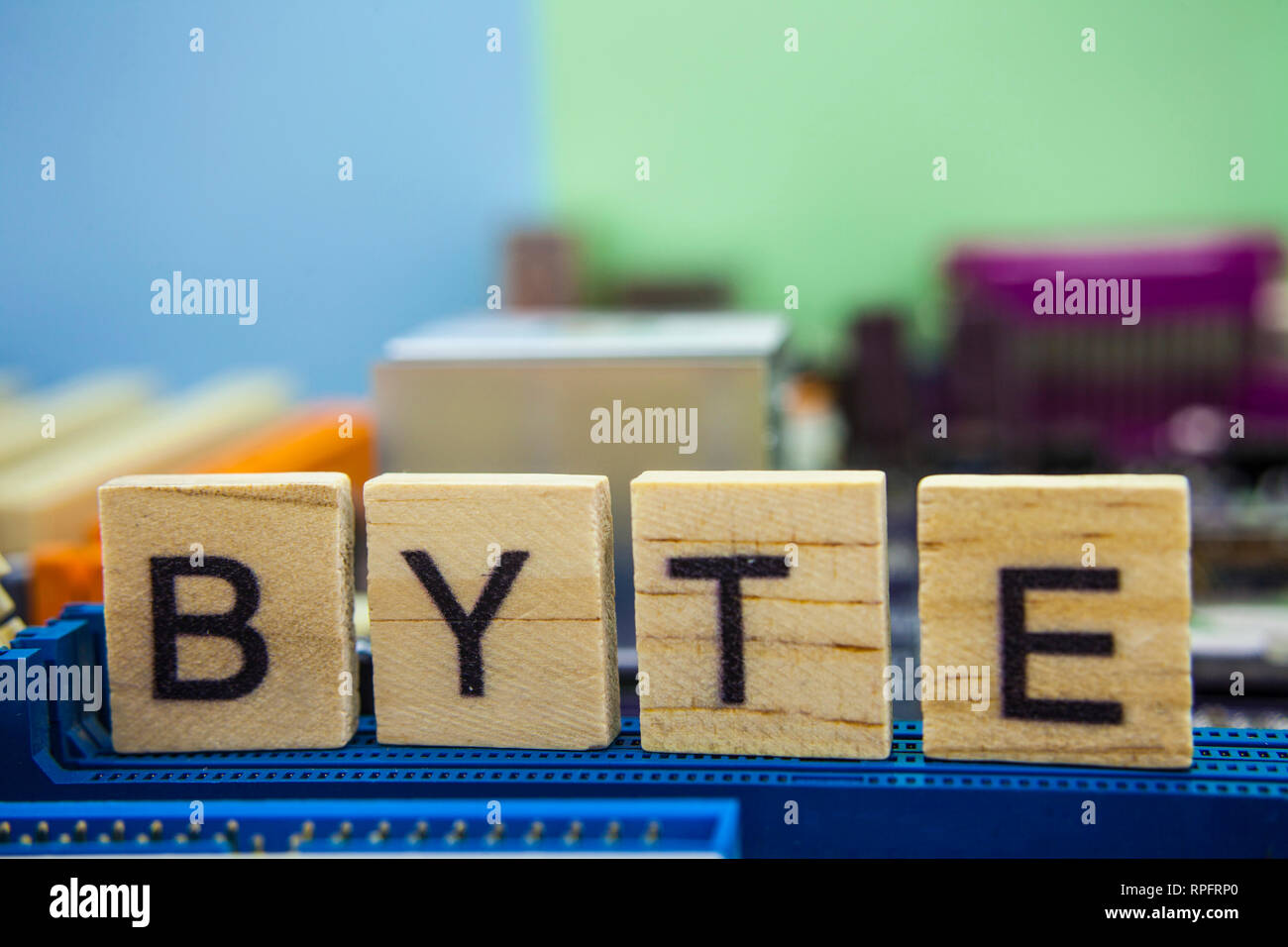 Word BYTE on the wooden blocks with computers mainboard background ...