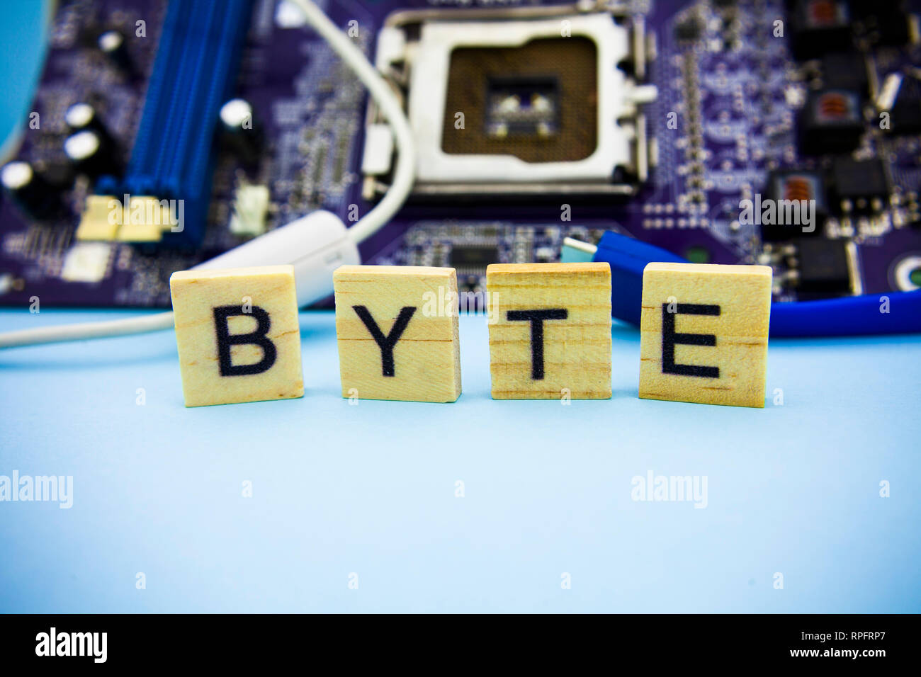 Word BYTE on the wooden blocks with computers mainboard background ...