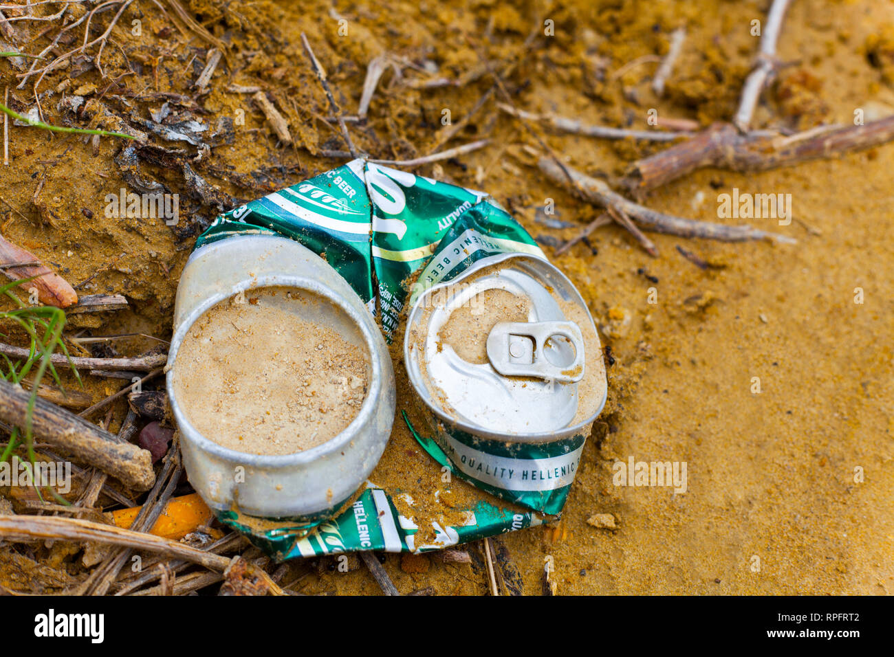 Squashed metal can on the ground. Nature and trash concept with garbage ...