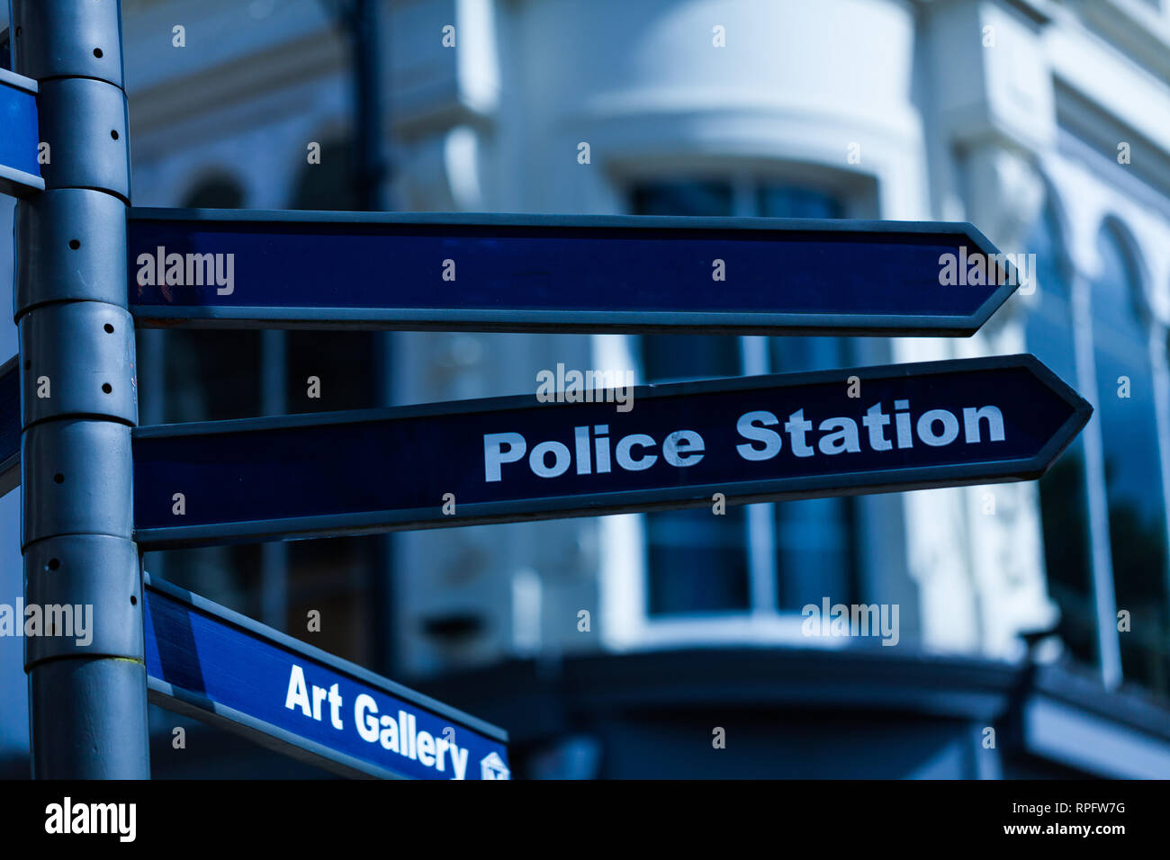 Police station street sign hanging on the lamppost. Arrow sign with ...