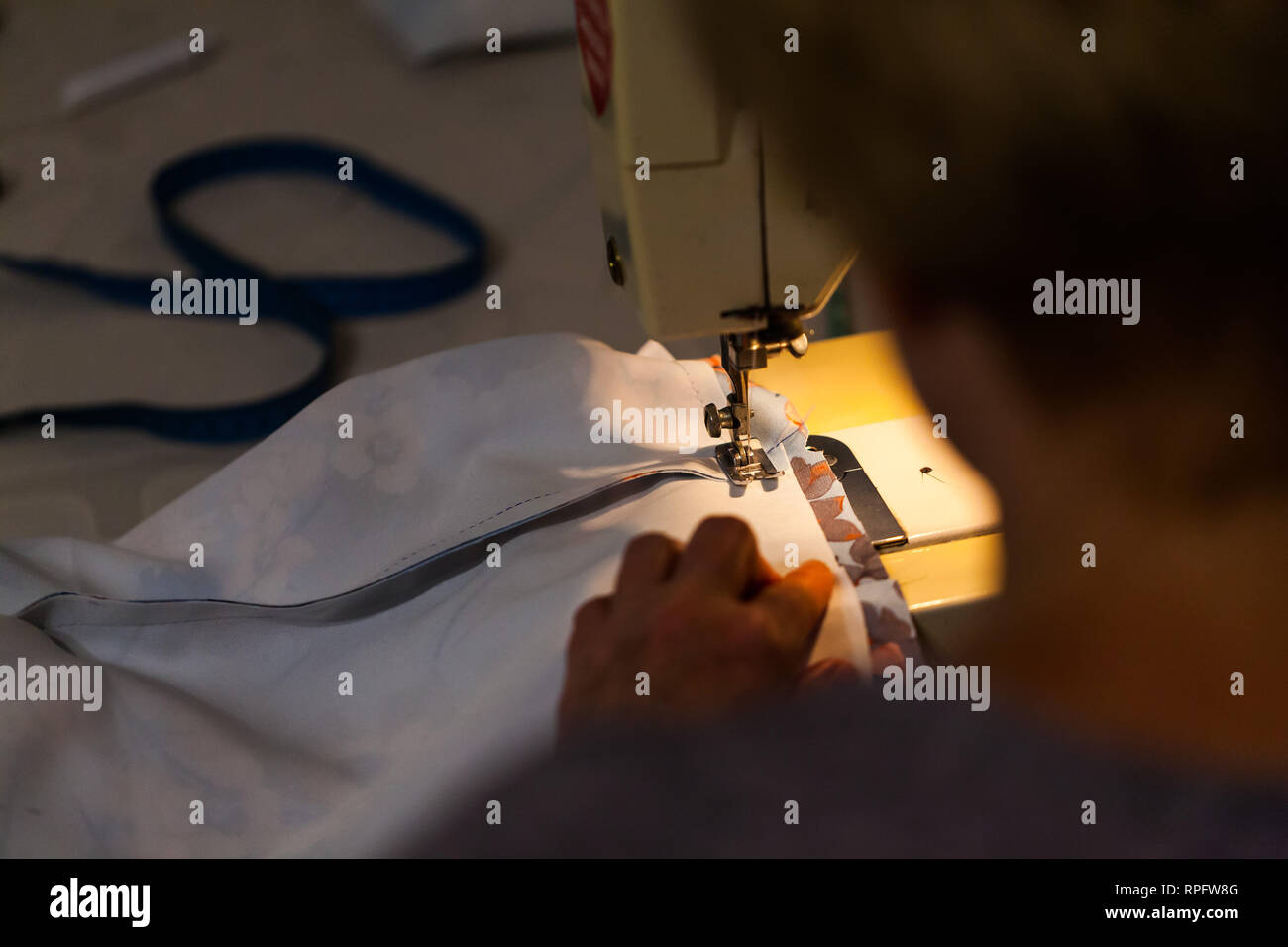 Women's hands on the sewing machine. Industry concept with creating ...