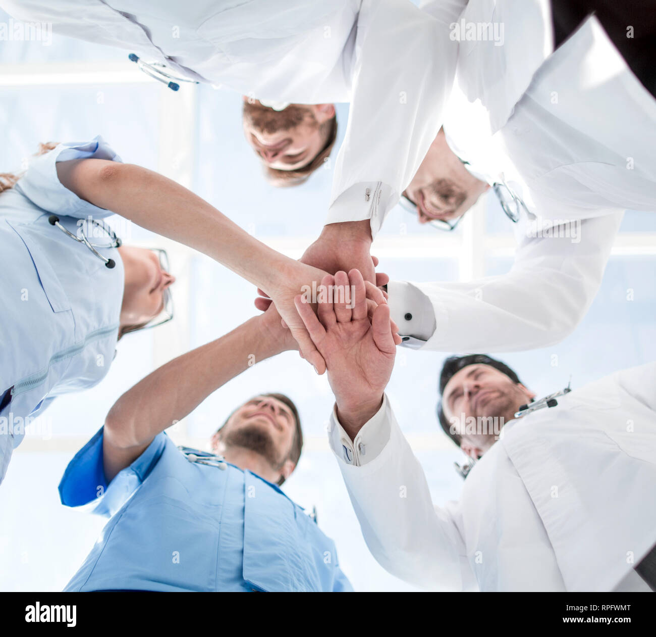 Health care workers demonstrating unity, bottom view Stock Photo - Alamy