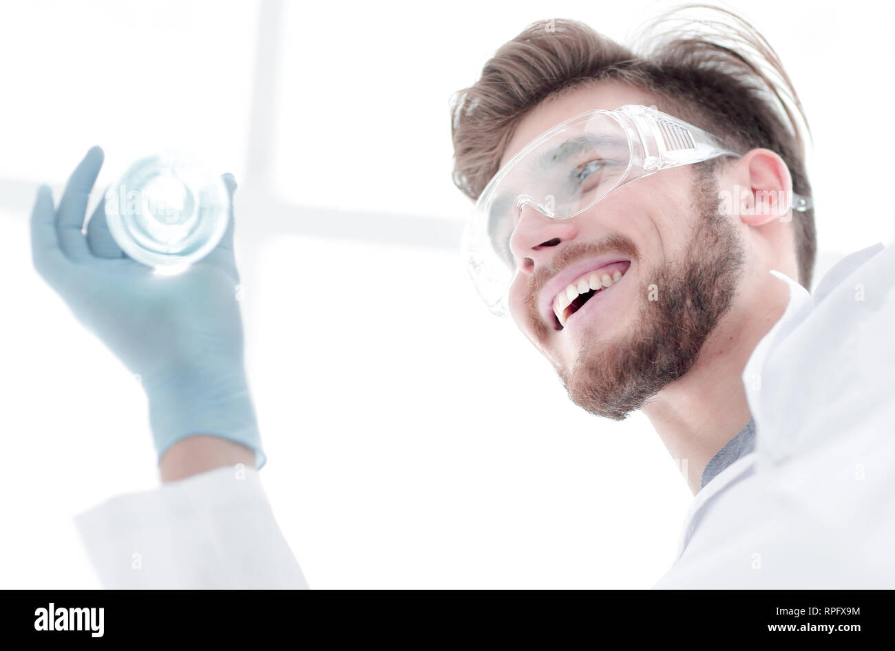 closeup.scientist holding beaker with the sample Stock Photo - Alamy