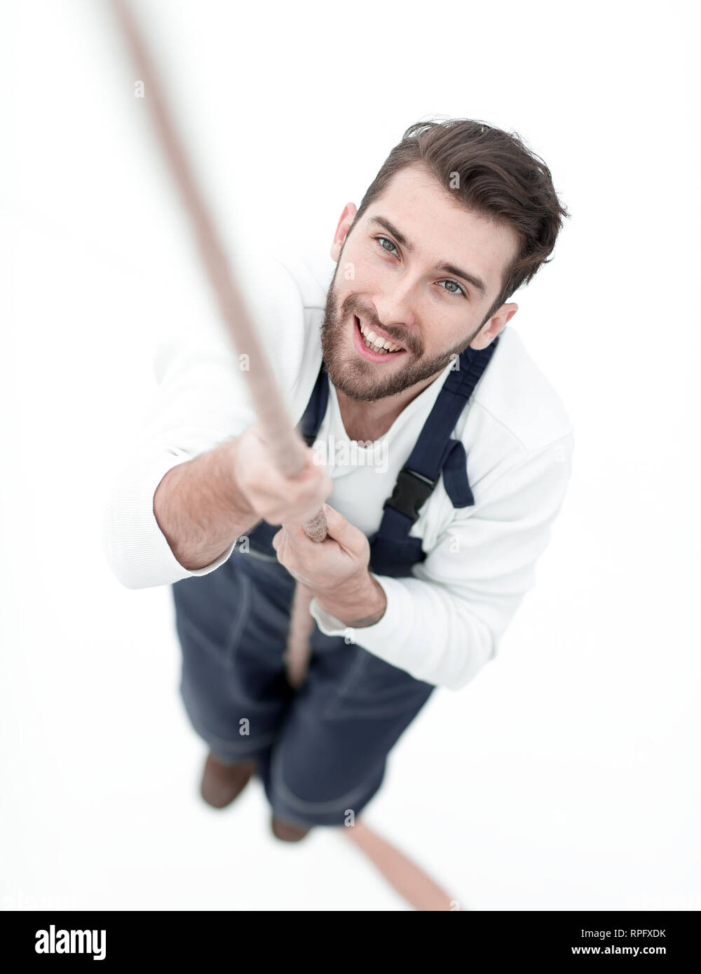 construction worker climbing the rope up Stock Photo - Alamy