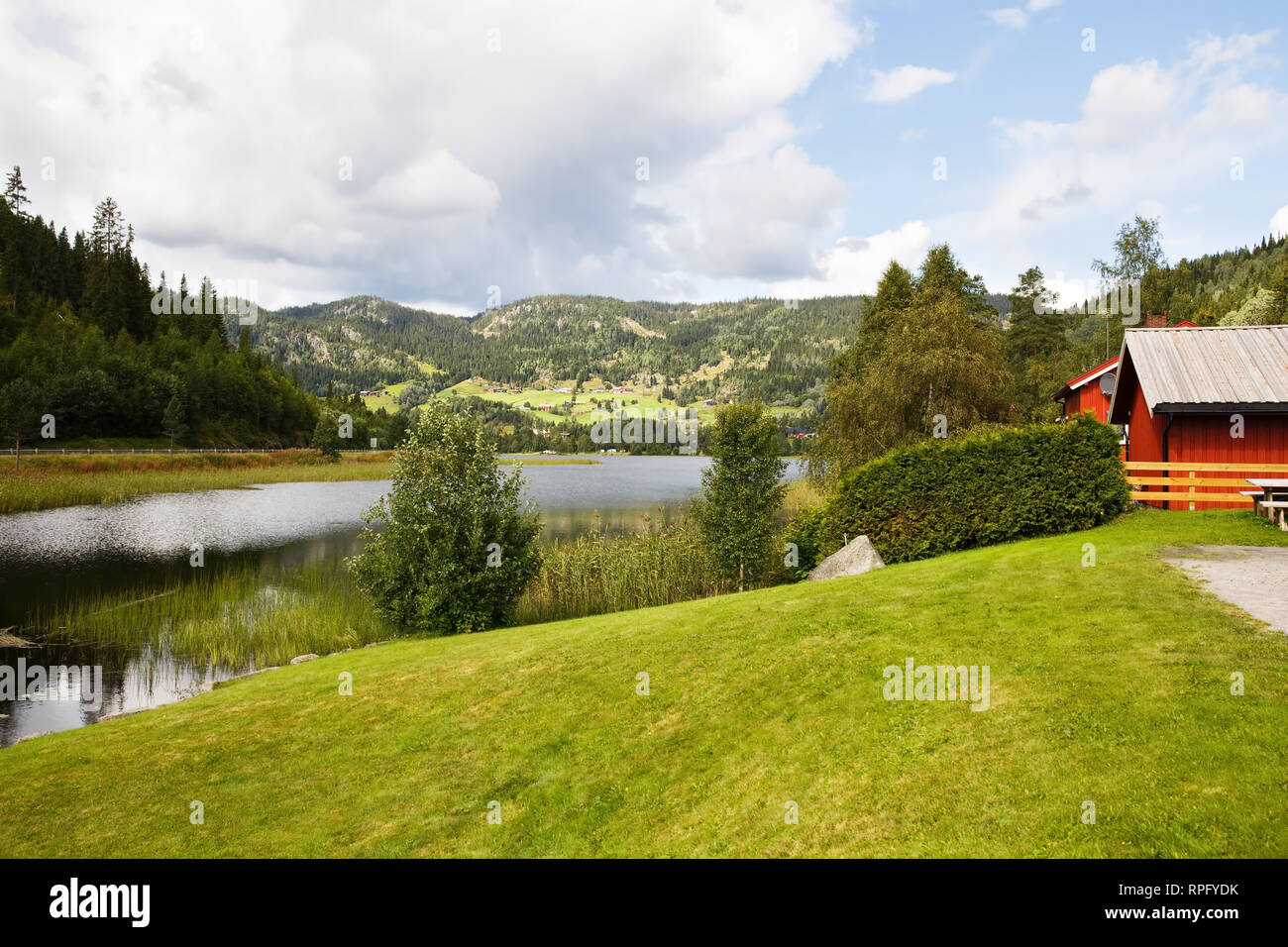 Beautiful rural scene with village, lake amd mountains in Norway Stock ...