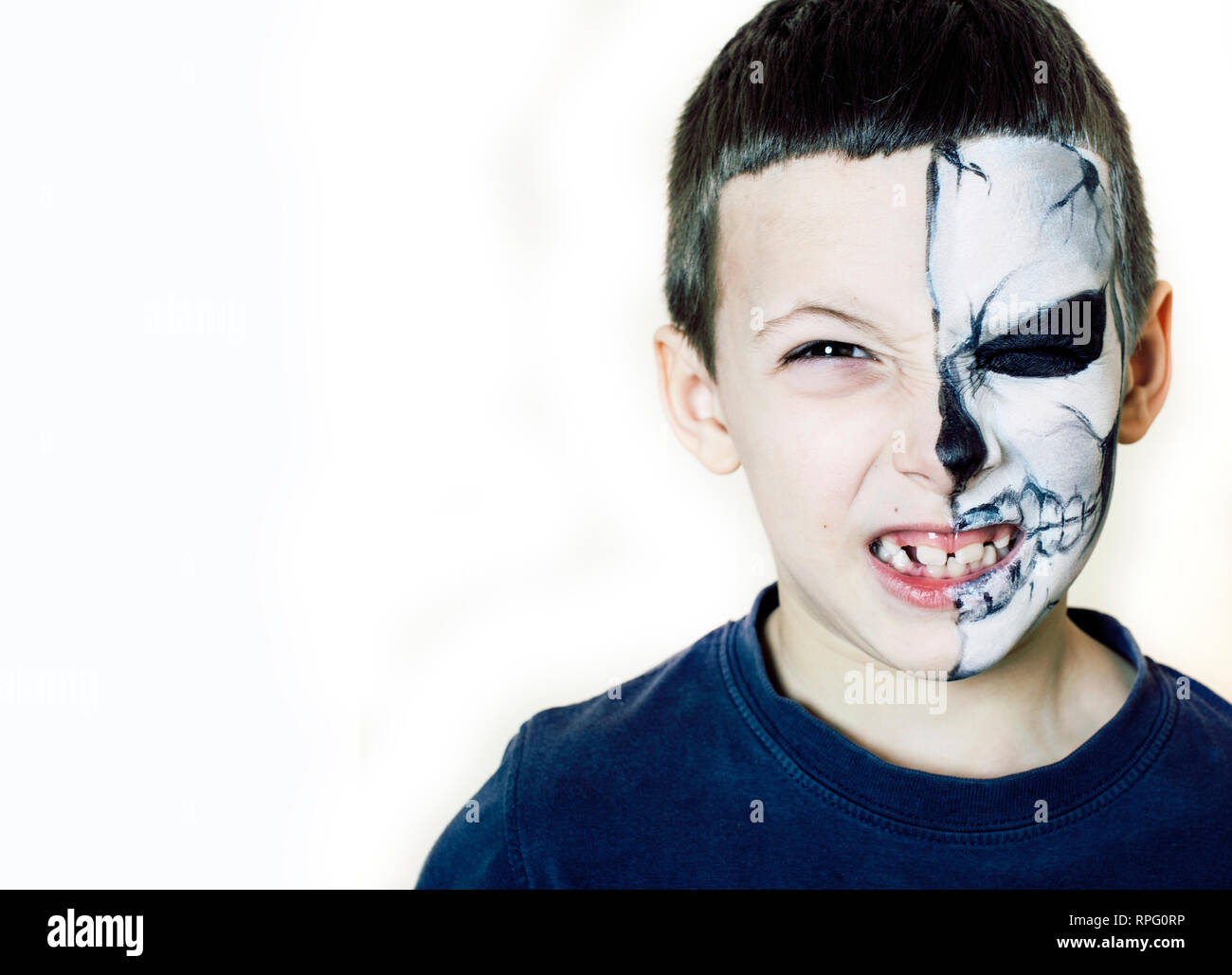 little cute boy with facepaint like skeleton to celebrate halloween ...