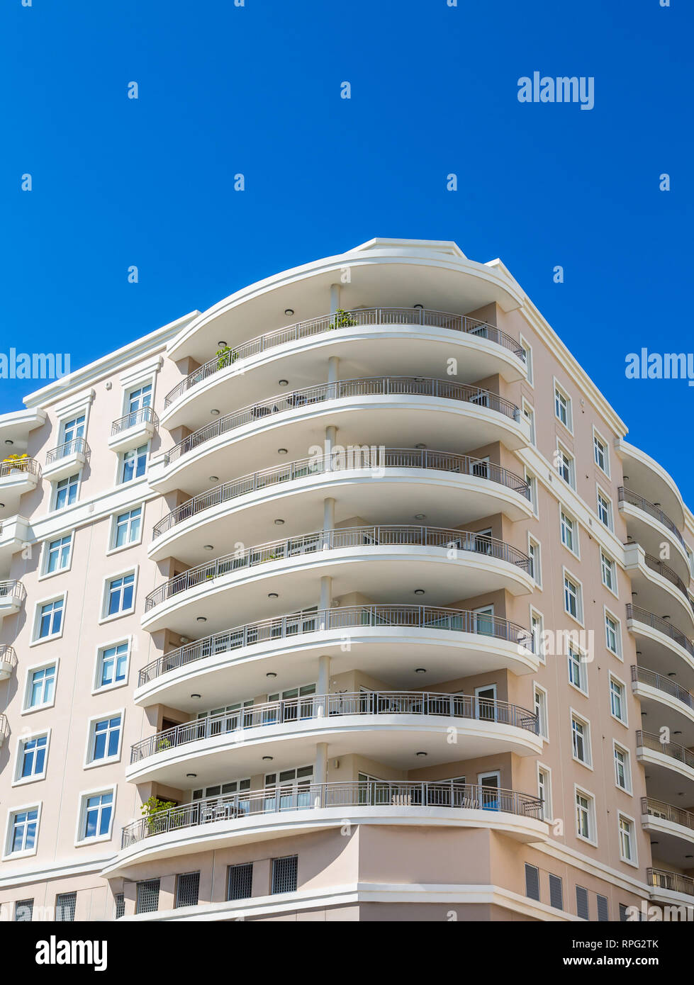 A modern stucco condo building with Large Curved Balconies Stock Photo ...