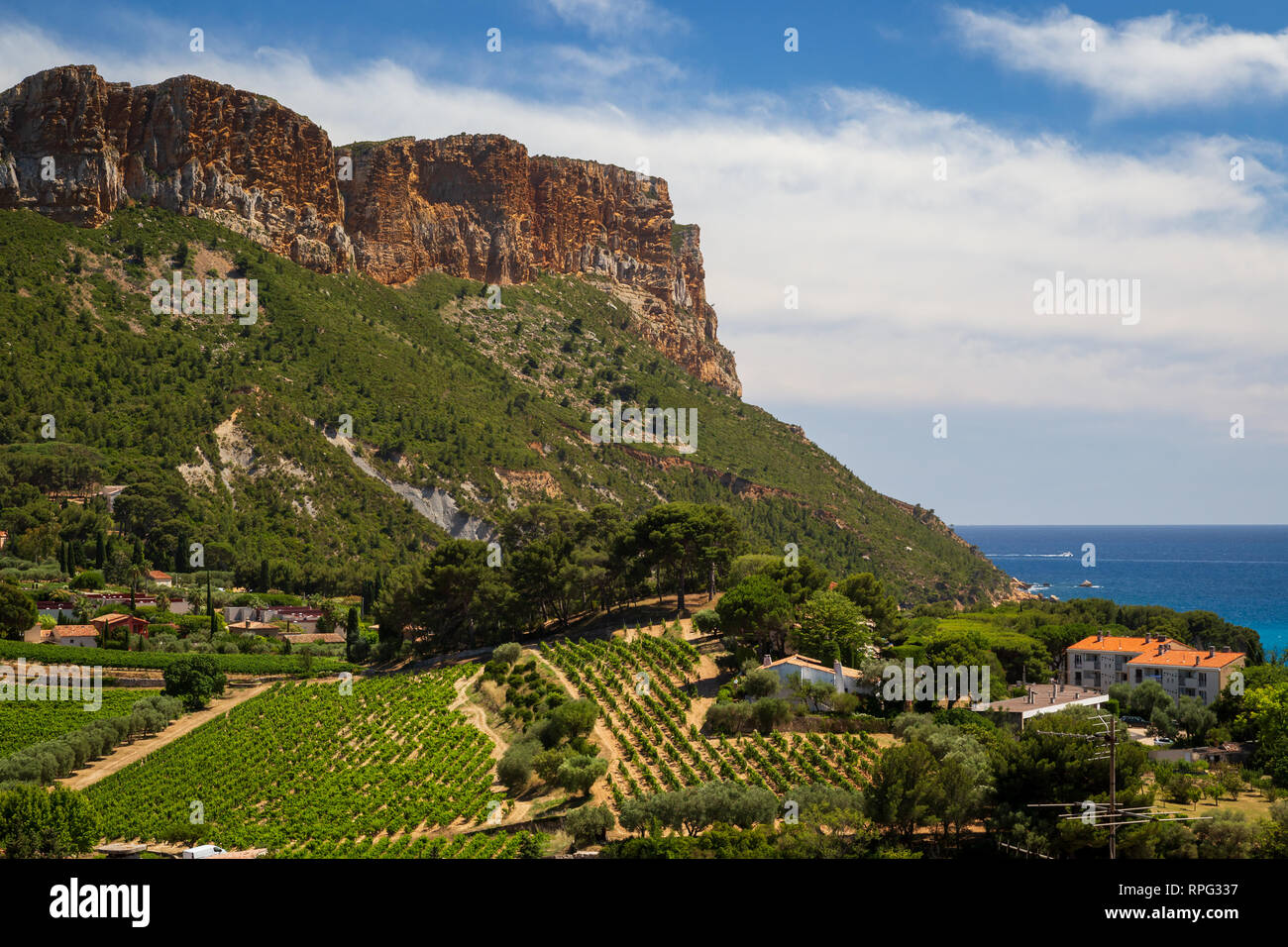 French landscape with vineyards and a small village at the base of a ...