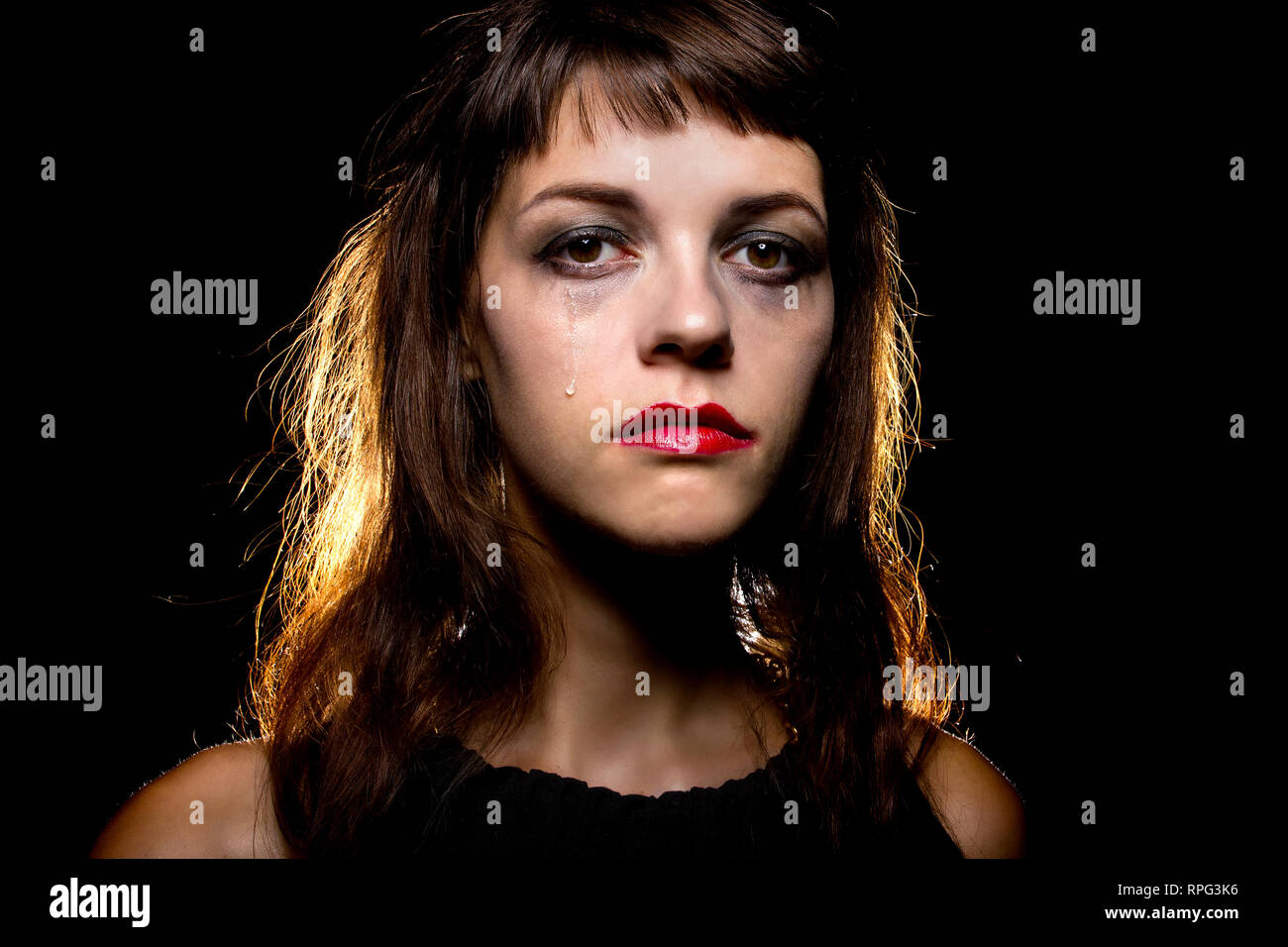 smeared make-up by crying tears on a noir style sad woman Stock Photo ...