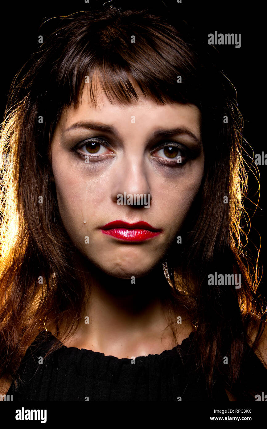 smeared make-up by crying tears on a noir style sad woman Stock Photo ...