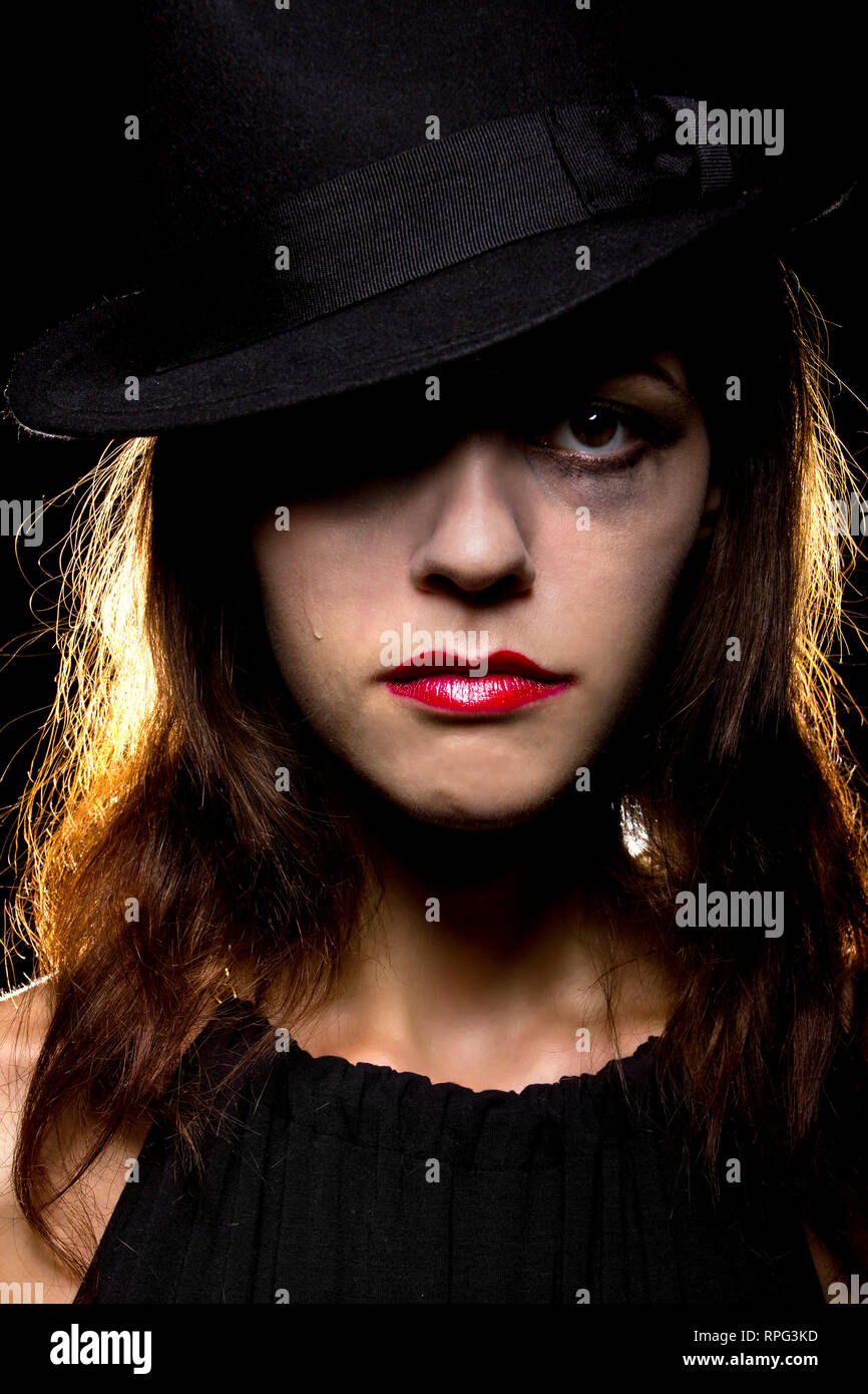smeared make-up by crying tears on a noir style sad woman Stock Photo ...