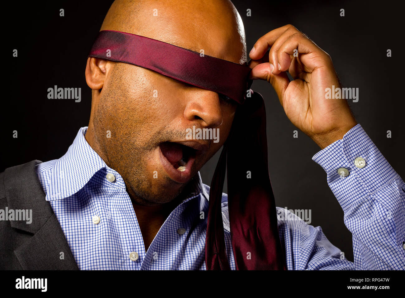 Black businessman blindfolded to represent corporate uncertainty Stock ...