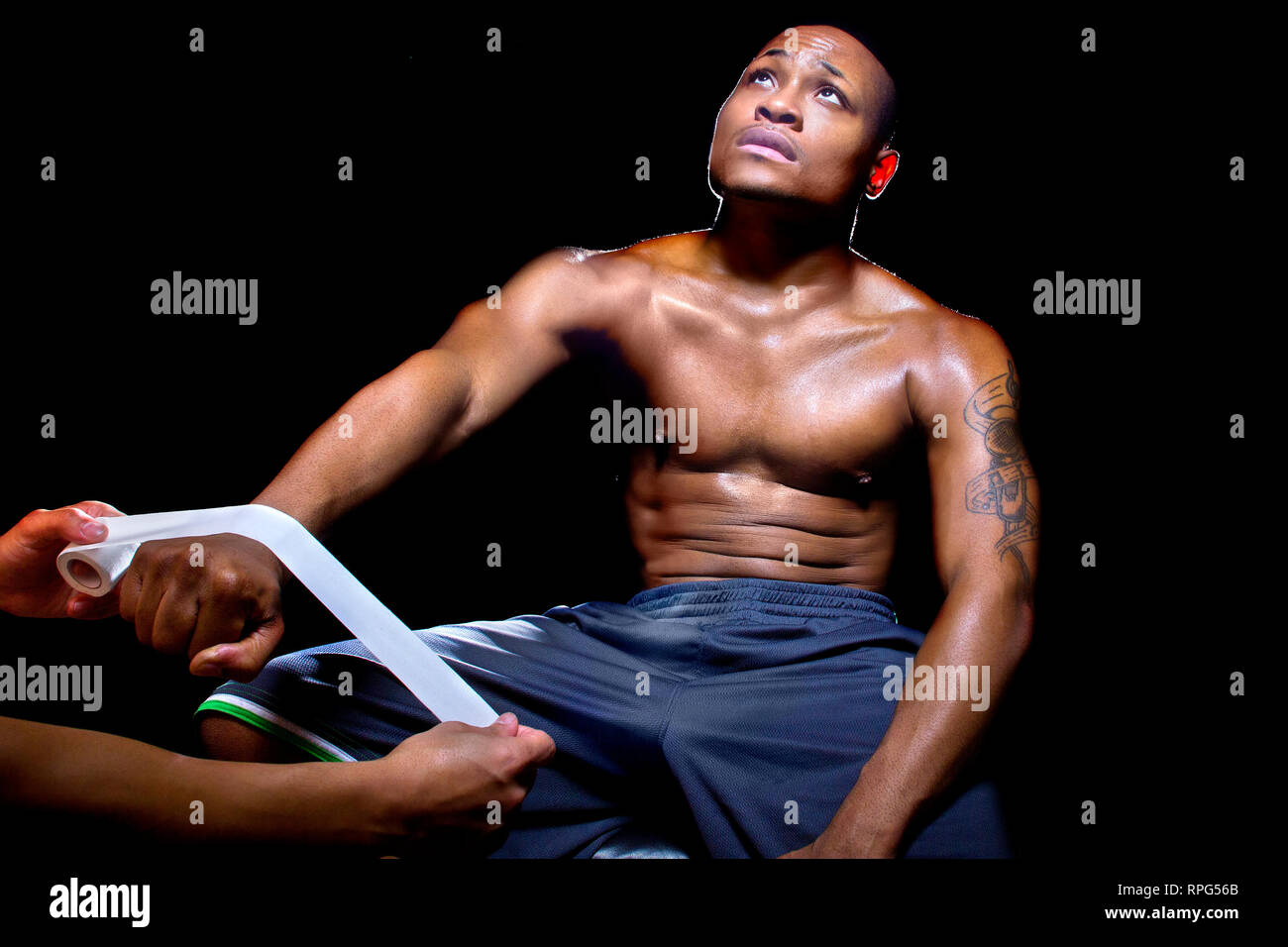 boxer or mma fighter looking up in prayer for victory while preparing ...