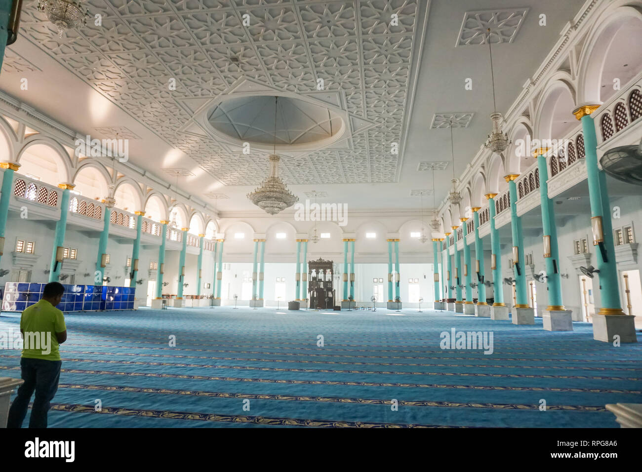 View of man performing prayer in the Blue Mosque of Sultan Ismail ...