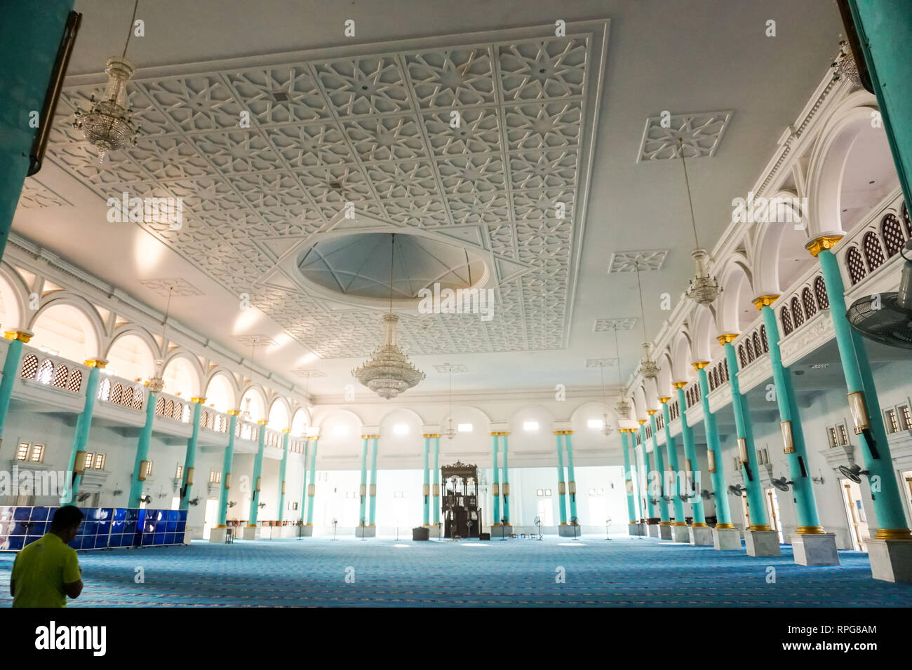 View of man performing prayer in the Blue Mosque of Sultan Ismail ...