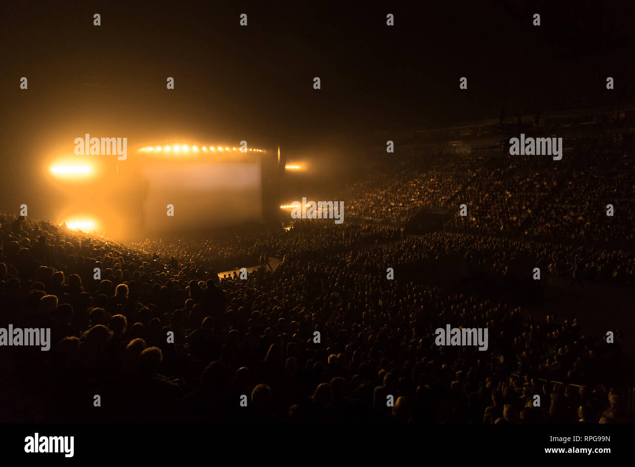lit up stage with many people background Stock Photo - Alamy
