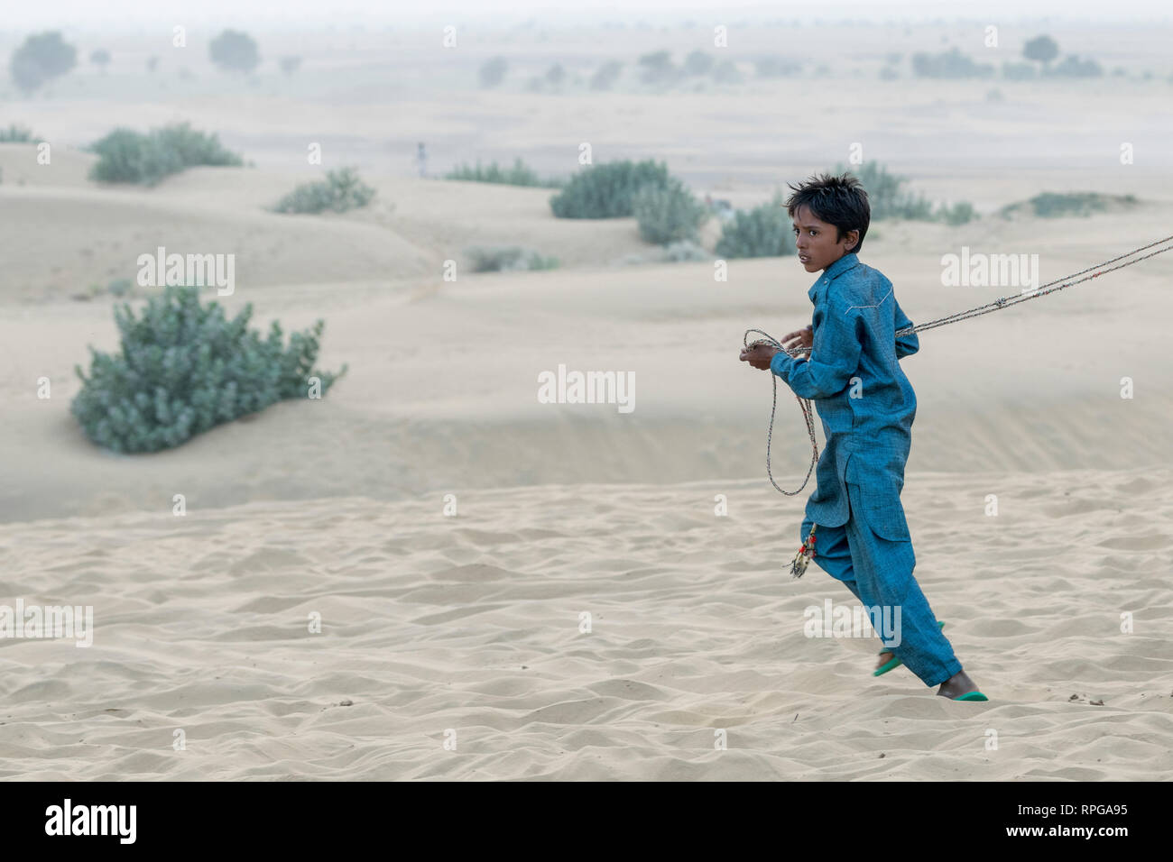 Boy pulling rope asia hi-res stock photography and images - Alamy
