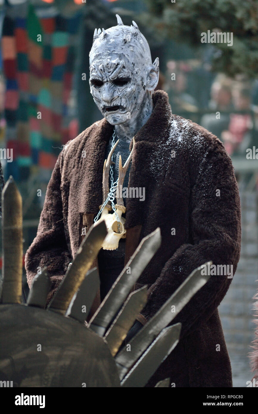 Disguised man walking down the street during carnival Stock Photo - Alamy