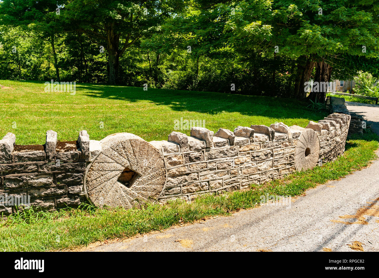 Rock fence with wheel design Stock Photo - Alamy