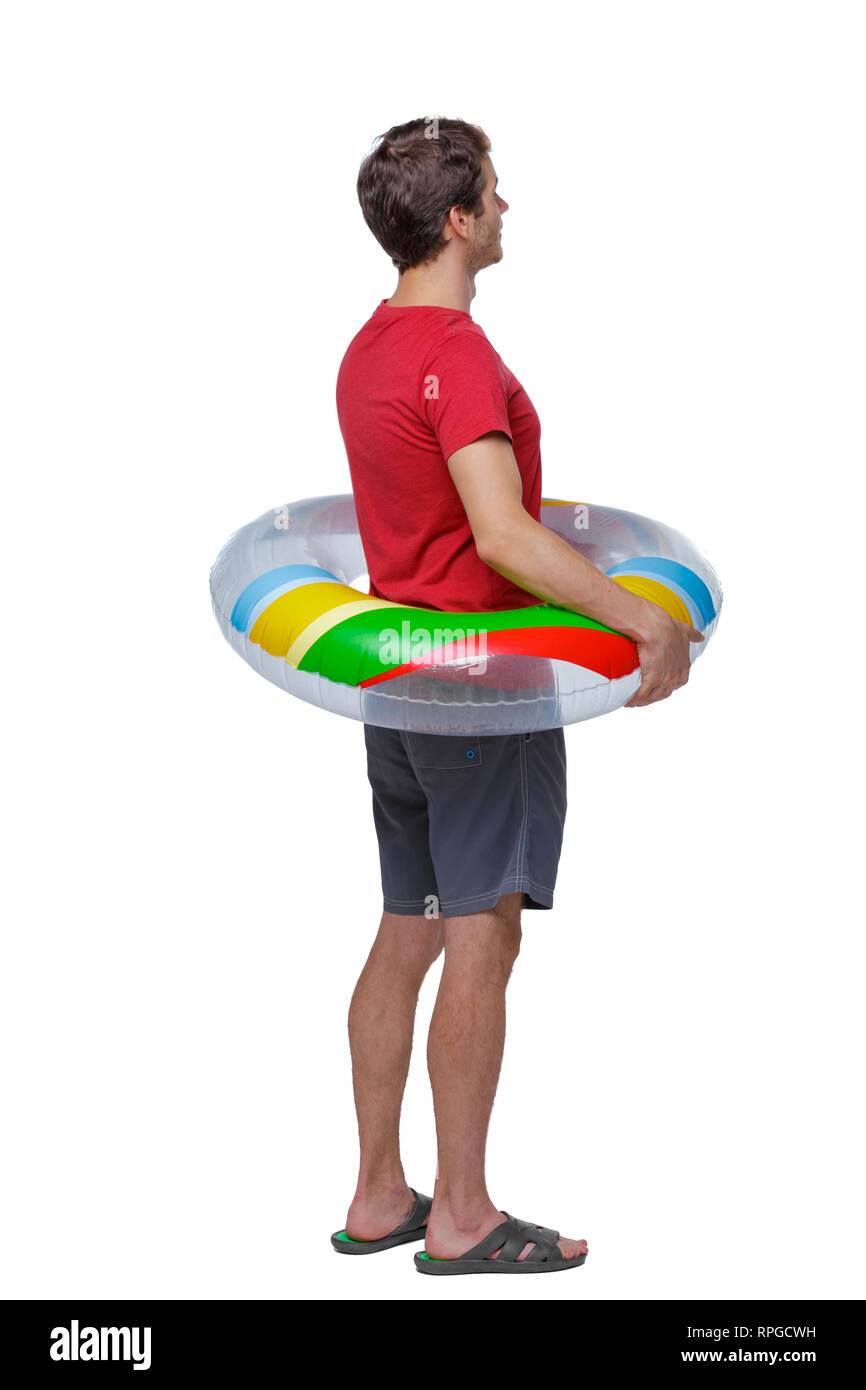 Back view of a man in shorts with an inflatable circle. The guy on the ...