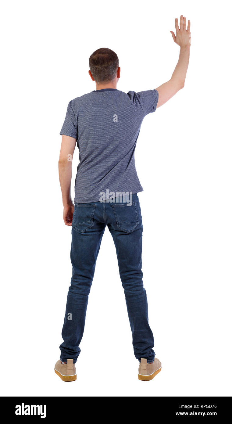Back view of a man in jeans points his hand upwards. Rear view people ...
