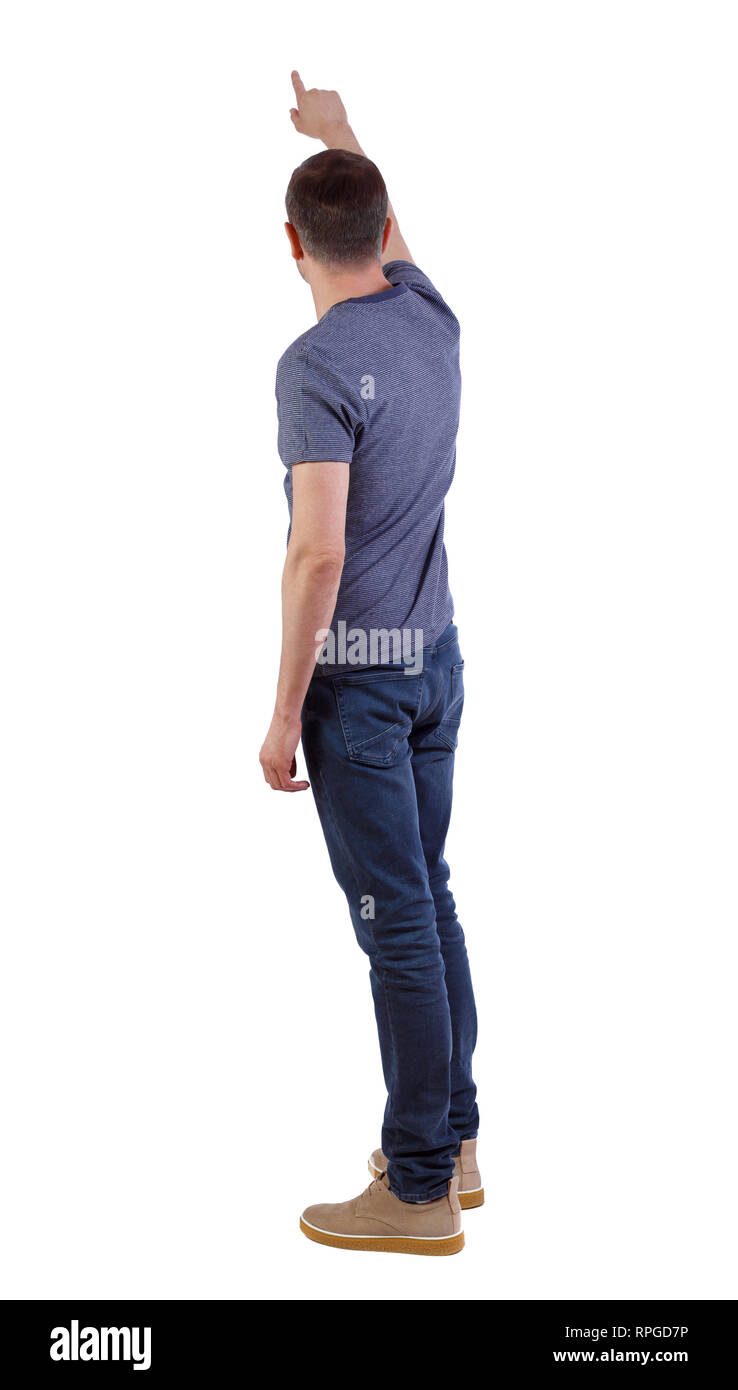 Back view of a man in jeans points his hand upwards. Rear view people ...