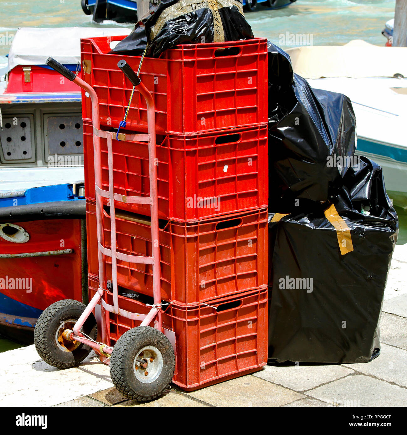 Delivery cart with red crates in Venice Stock Photo - Alamy