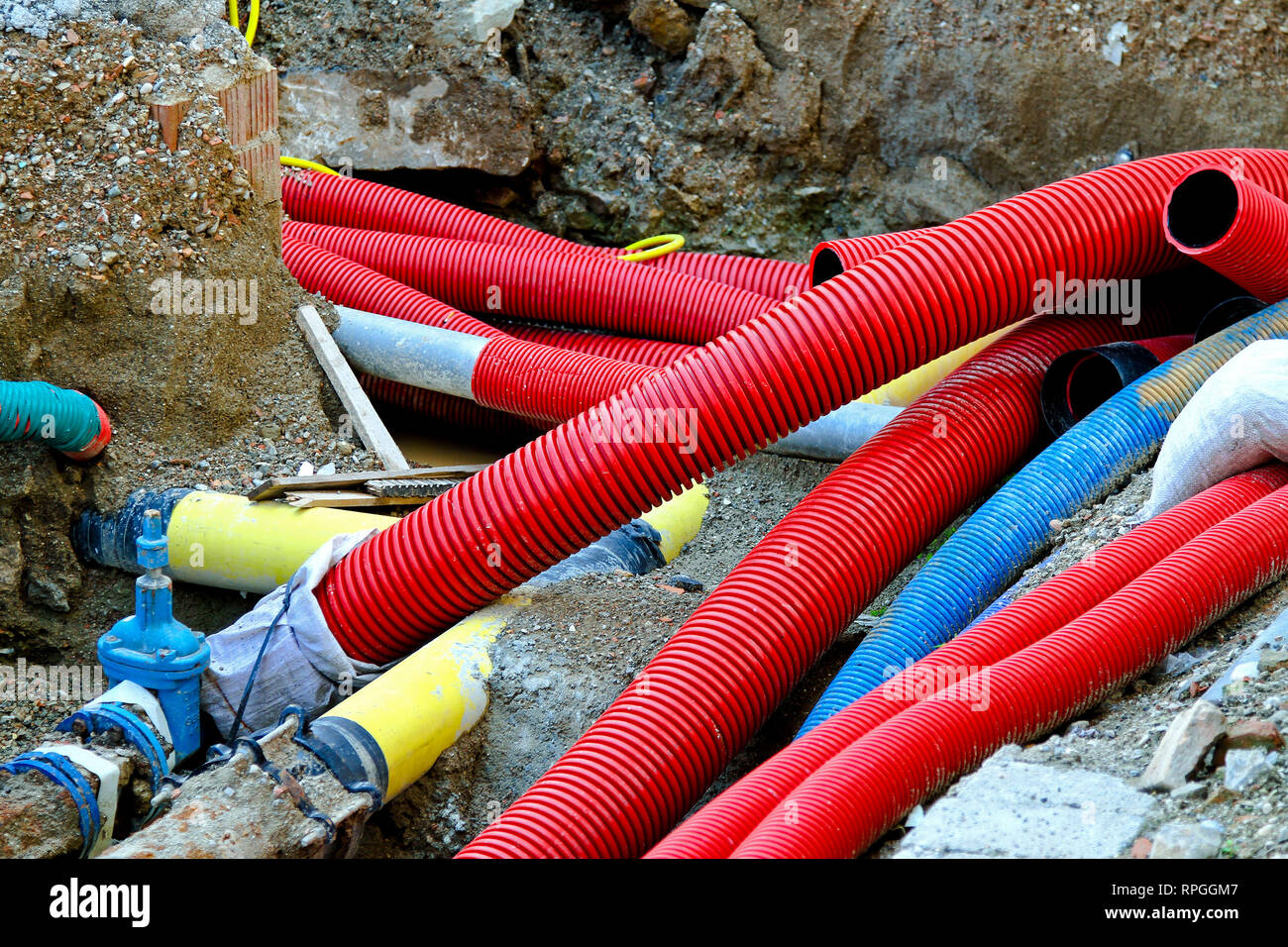 Underground construction of pipes hoses and cables Stock Photo - Alamy