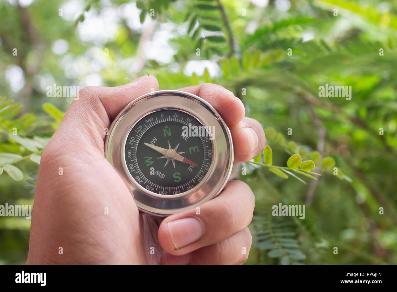 Hand holding compass hi-res stock photography and images - Alamy