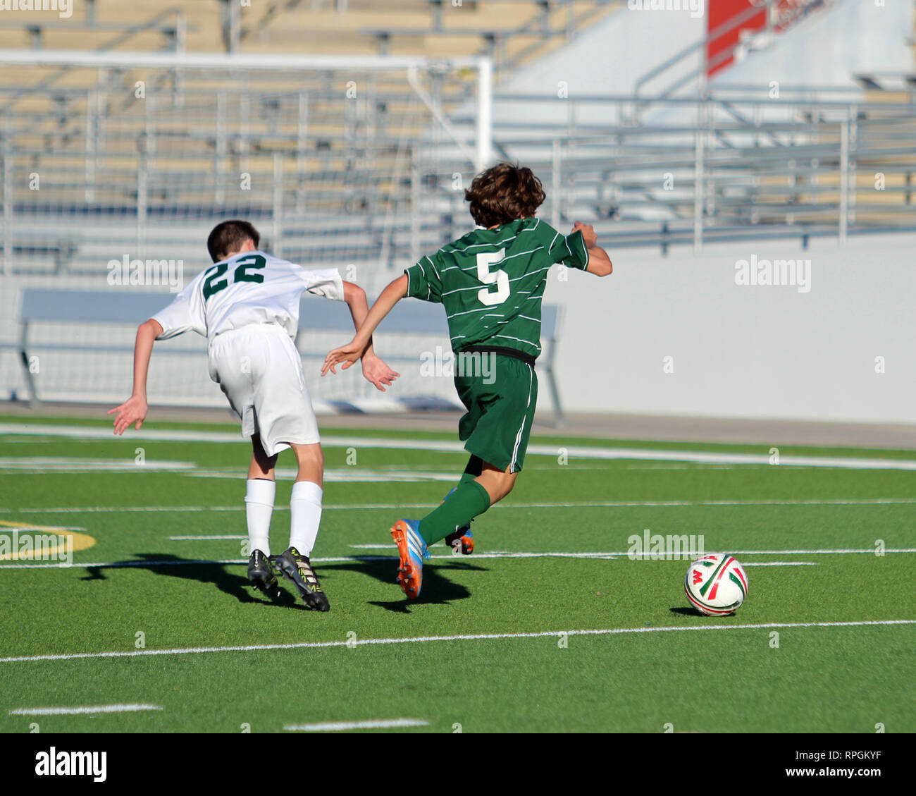Defender knocks an offensive player off the ball in high school boys ...