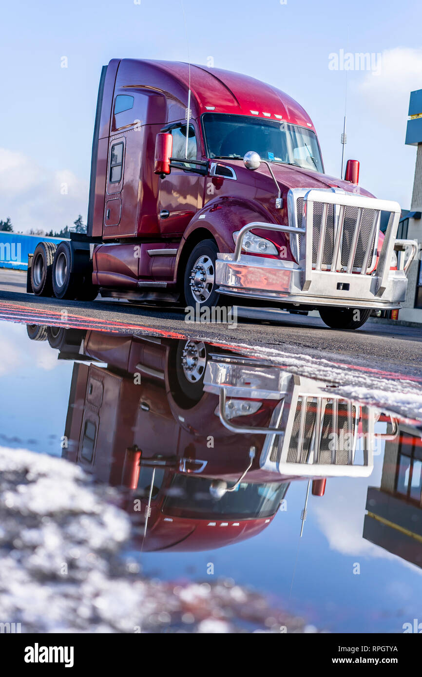 Red big rig semi truck tractor for industrial freight in American ...
