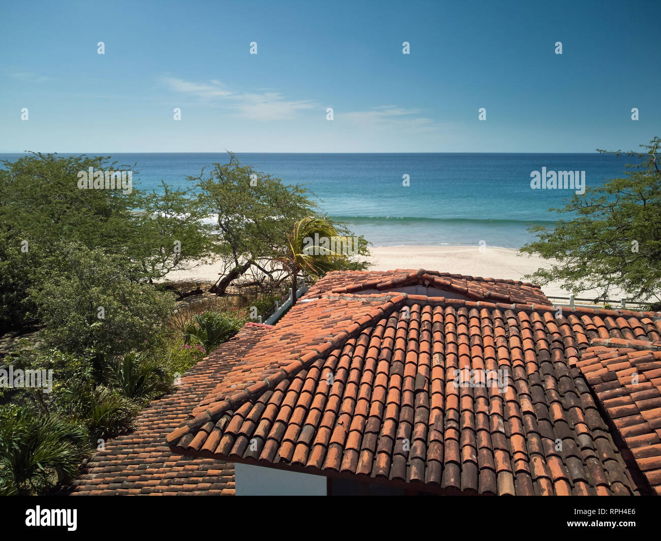 Red tiled roof of villa house on ocean beach Stock Photo - Alamy