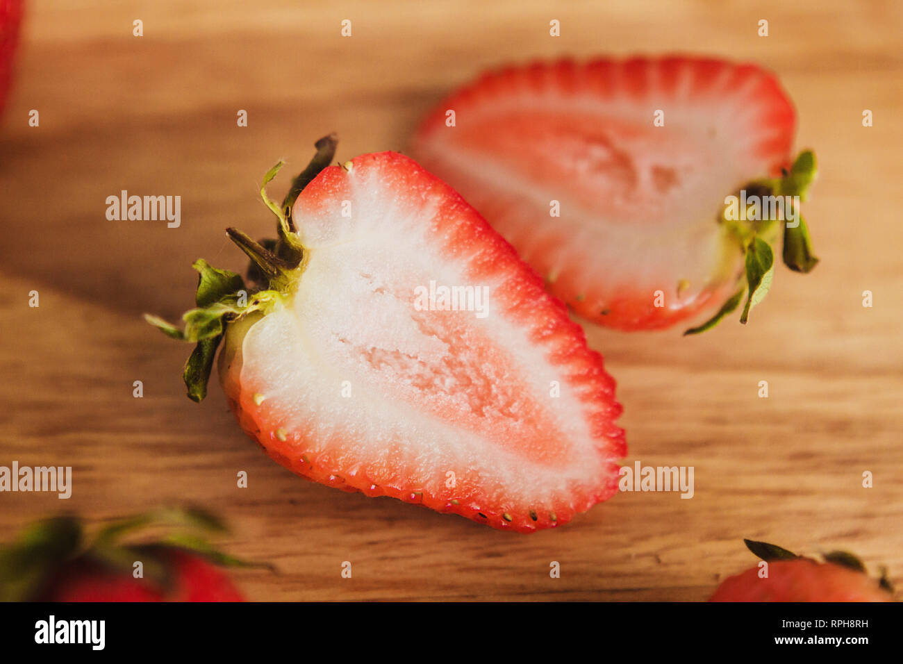 open strawberries in a wood background Stock Photo - Alamy