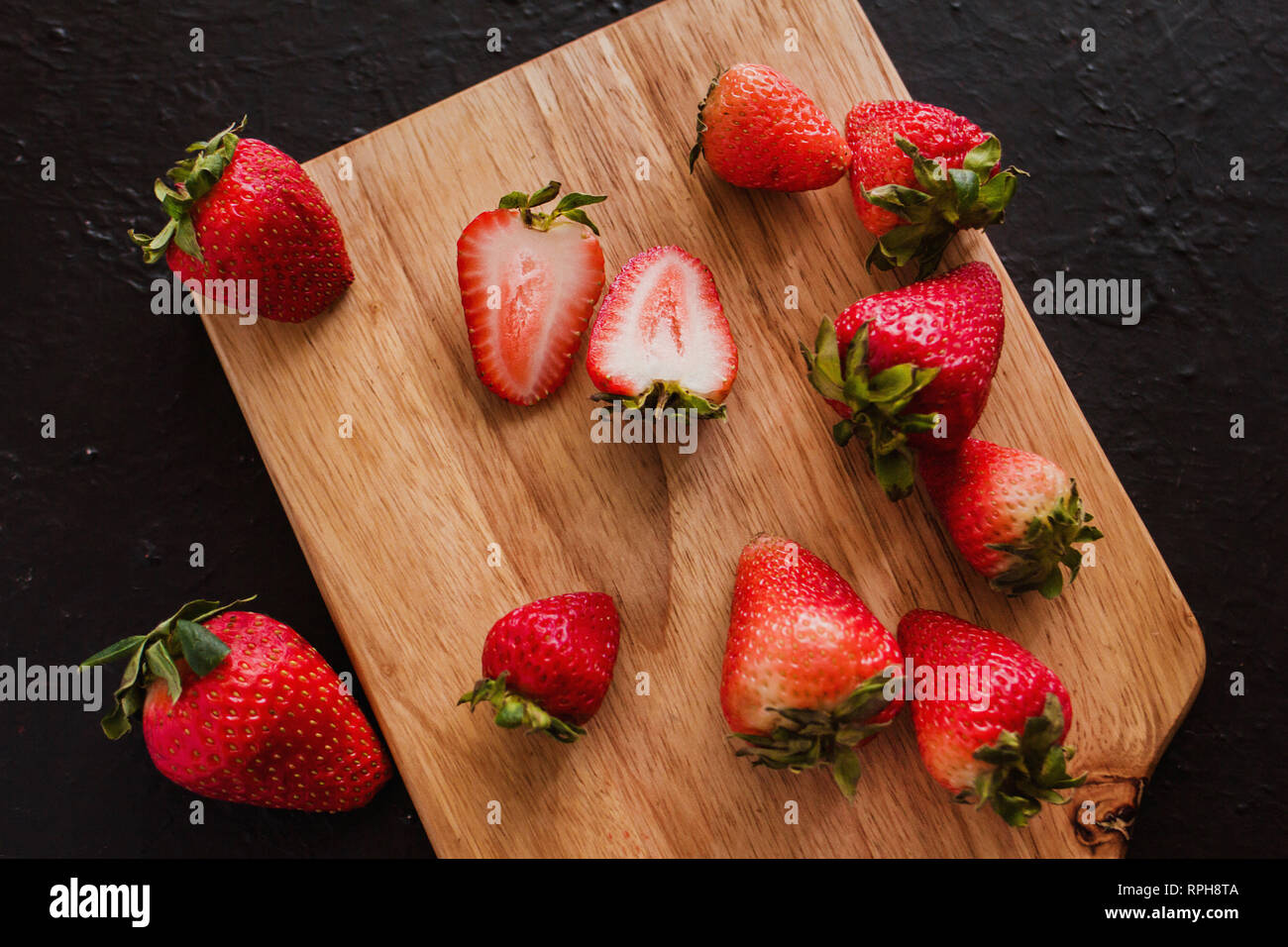 strawberries in a black background Stock Photo - Alamy