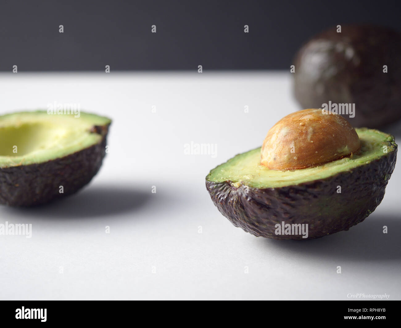Whole and halved avocado Stock Photo - Alamy