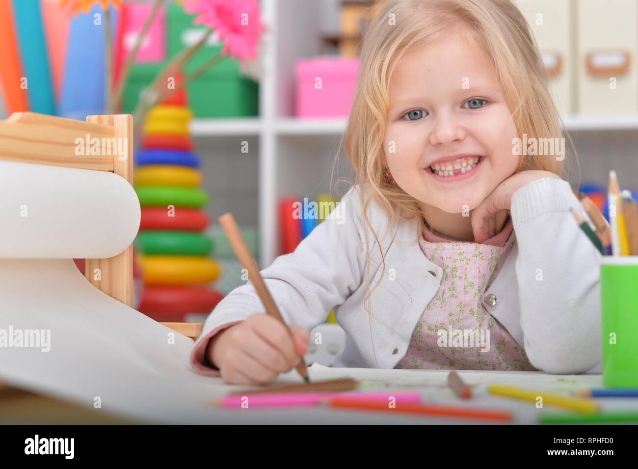 Cute little girl drawing with pencil at her room Stock Photo - Alamy