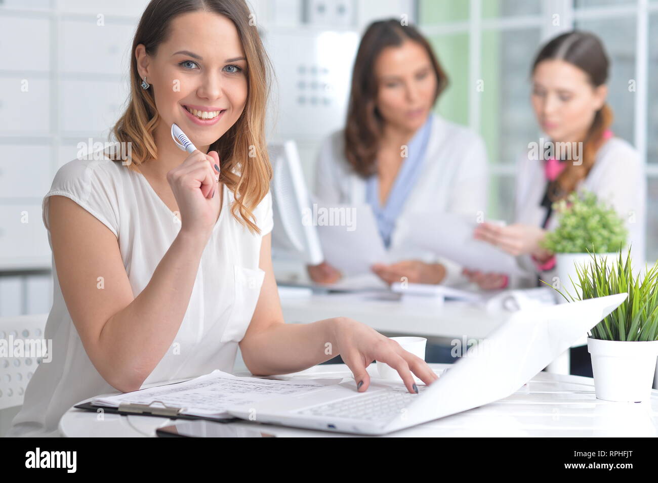 Young beautiful women working in modern office Stock Photo - Alamy