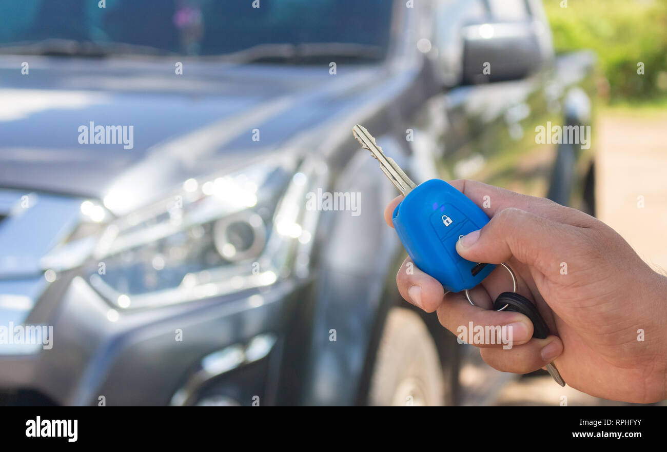 Car blue keys in hand to unlock door Stock Photo - Alamy