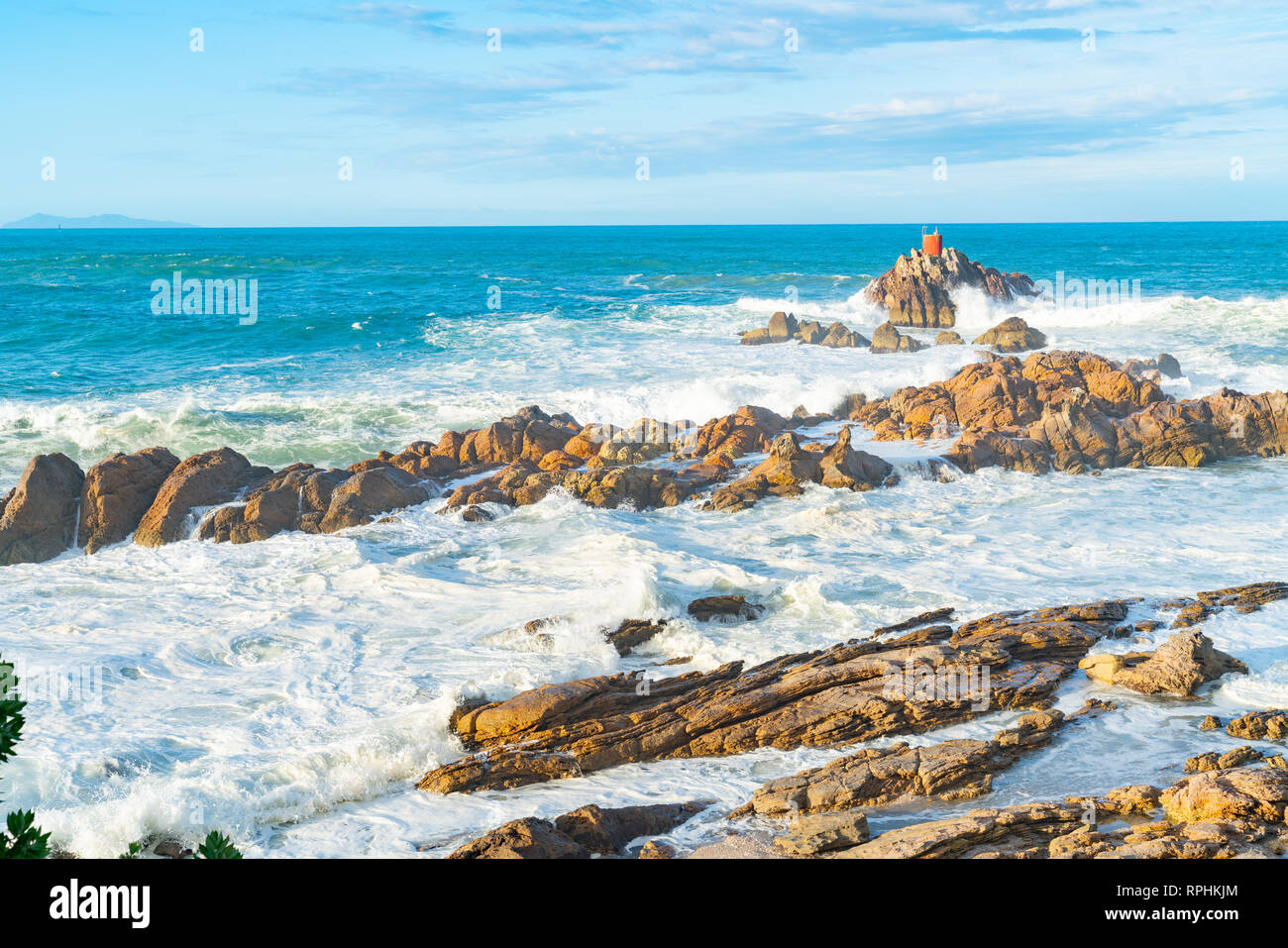Storm waves crashing into rhyolite rocky foreshore at base of Mount ...