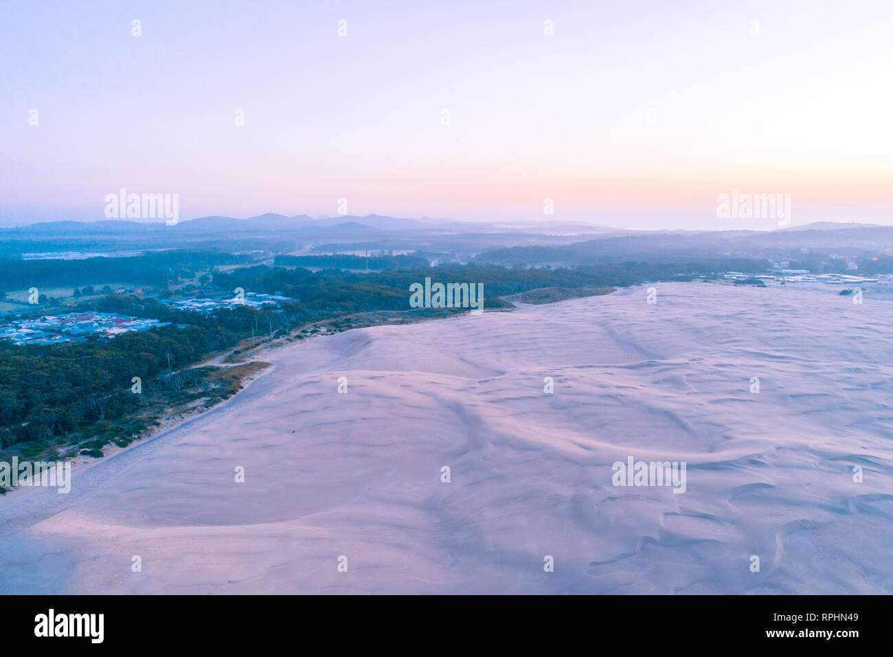 Beautiful white sand dunes and surrounding hills at sunrise. Anna Bay ...