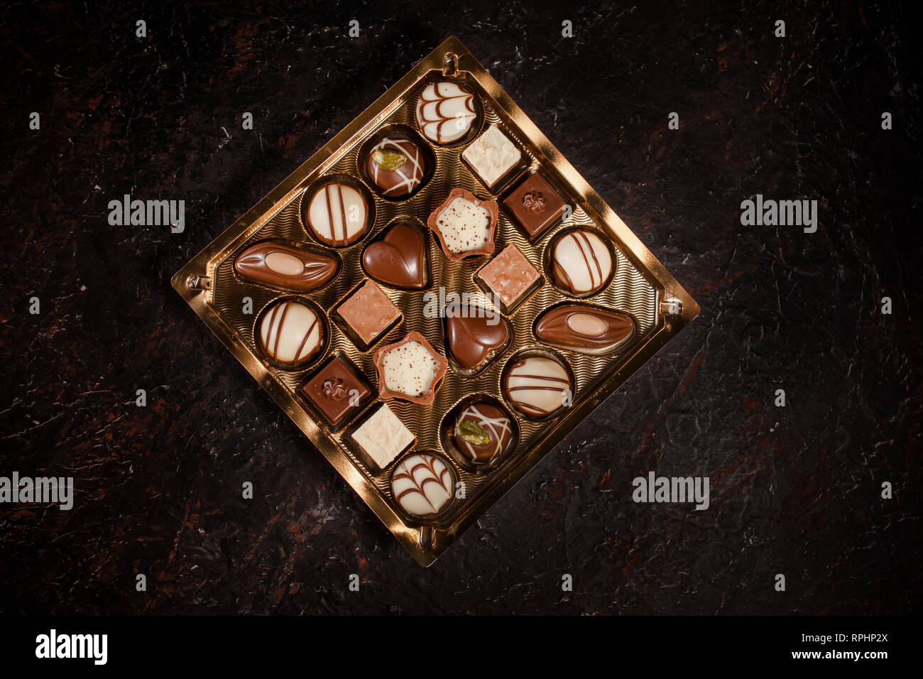 Box of assorted chocolates on black background Stock Photo - Alamy