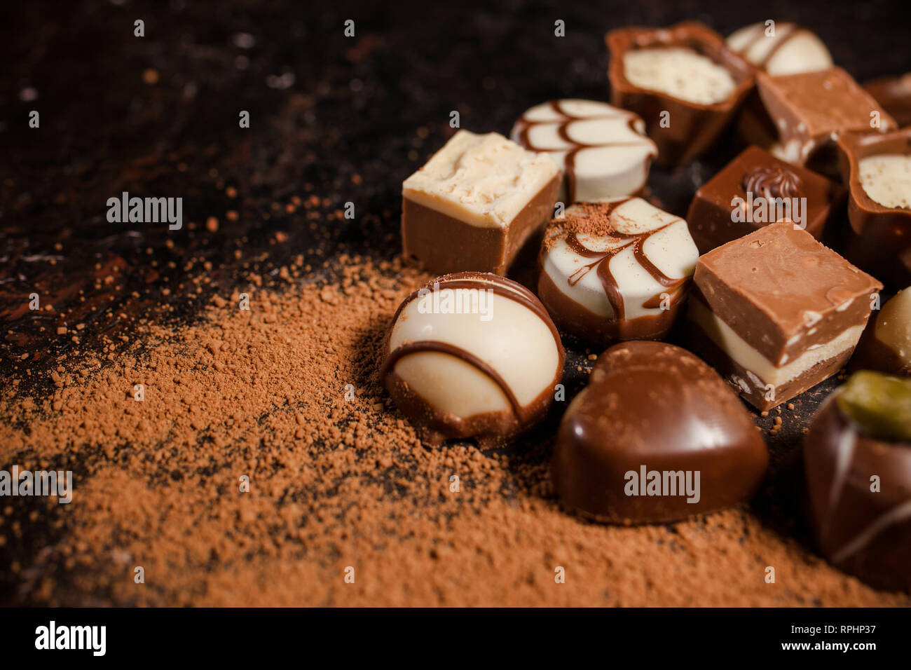 Box of assorted chocolates on black background Stock Photo - Alamy