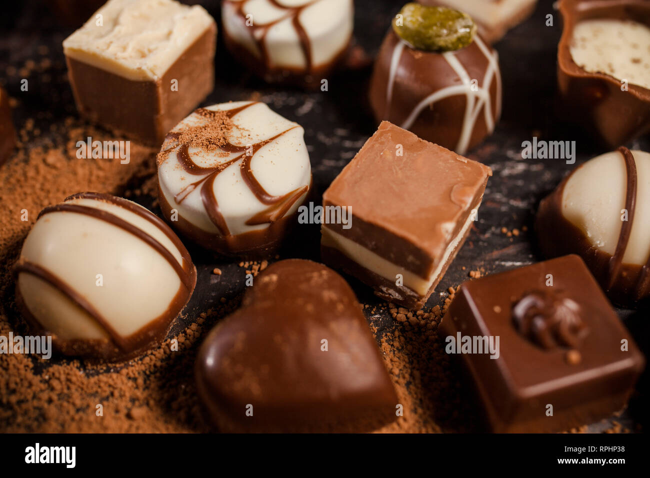 Box of assorted chocolates on black background Stock Photo - Alamy